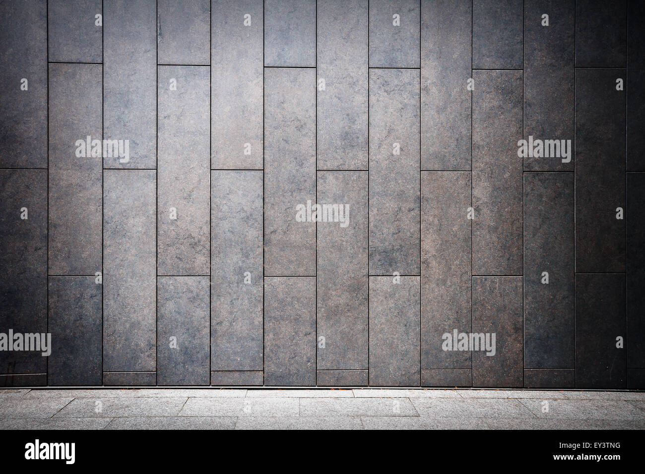 Modern dark stone tile wall and sidewalk Stock Photo - Alamy