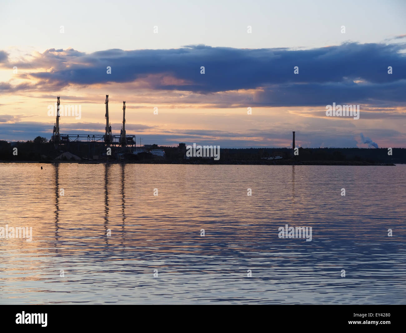 an industrial city on the shore of lake at sunset Stock Photo - Alamy