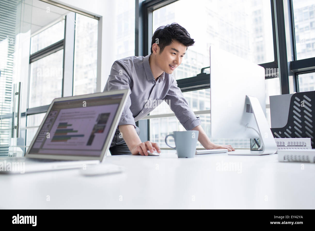 Young businessman using computer in office Stock Photo - Alamy