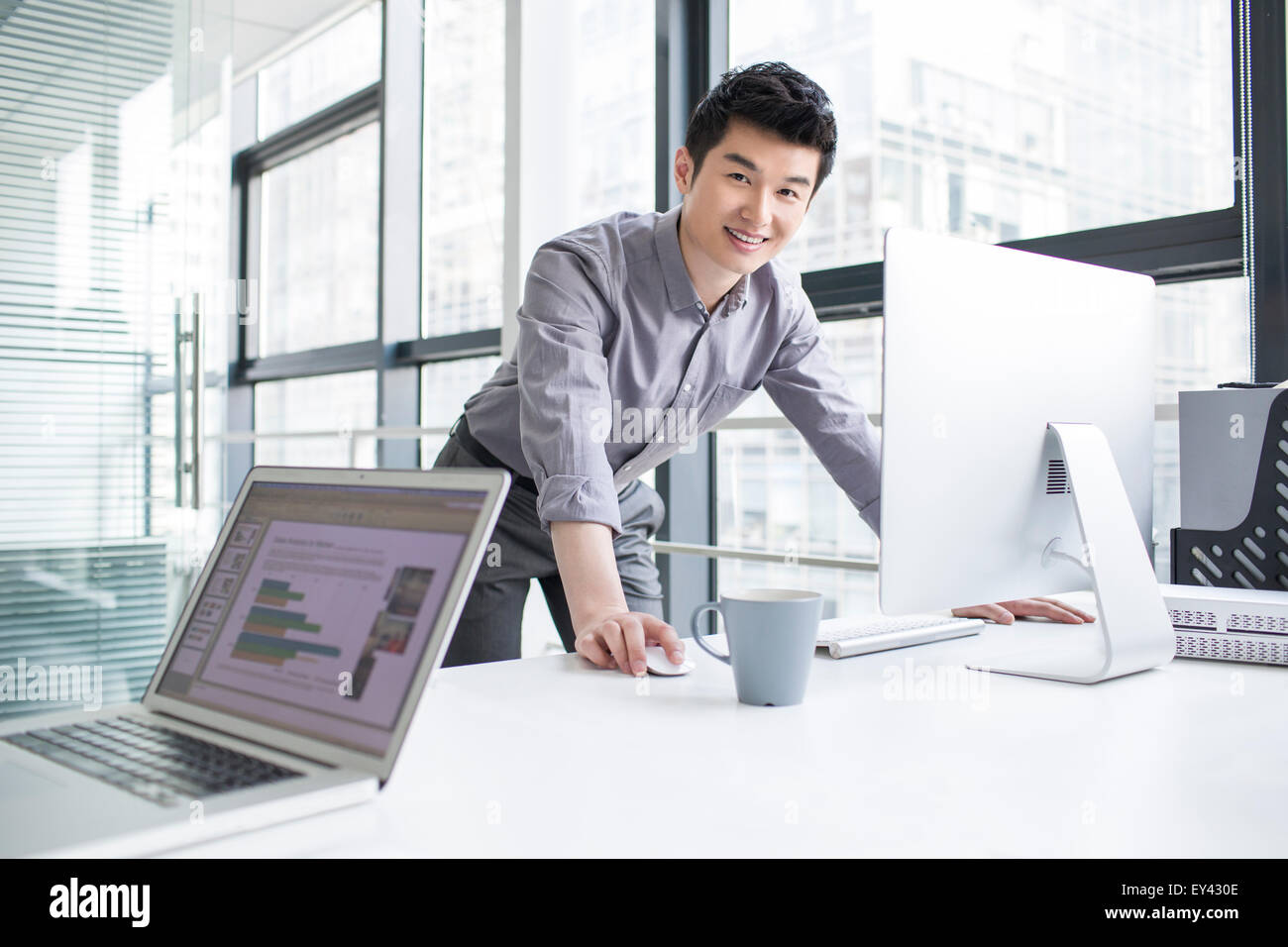 Young businessman using computer in office Stock Photo - Alamy