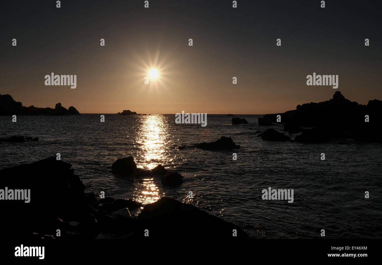 Sunset over Guernsey beach Stock Photo - Alamy