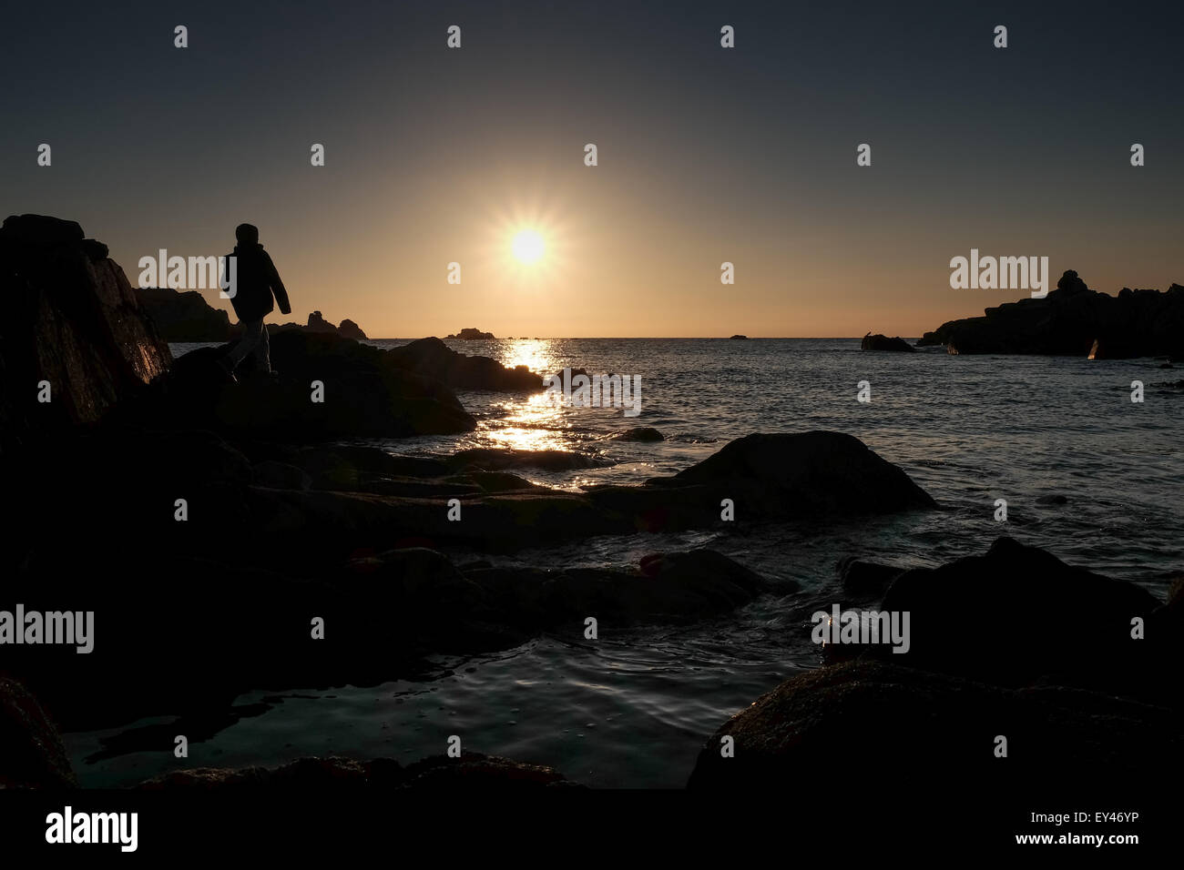 Sunset over Guernsey beach Stock Photo - Alamy