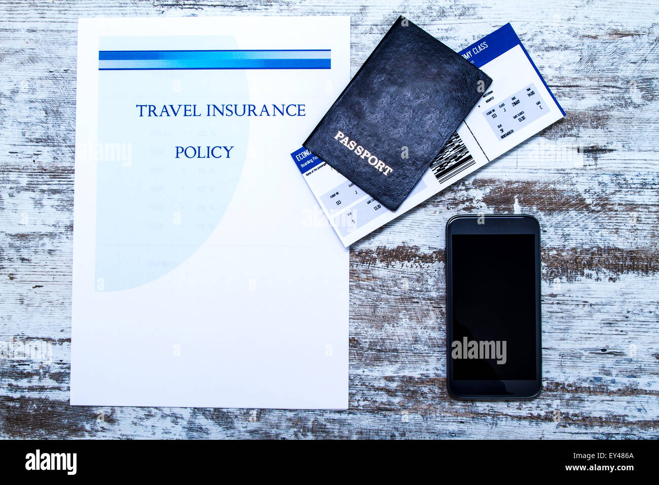 Travel insurance policy booklet with a boarding pass and a passport ...