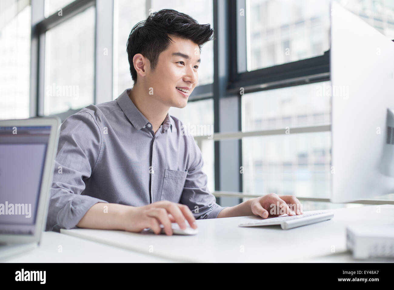 Young businessman using computer in office Stock Photo - Alamy