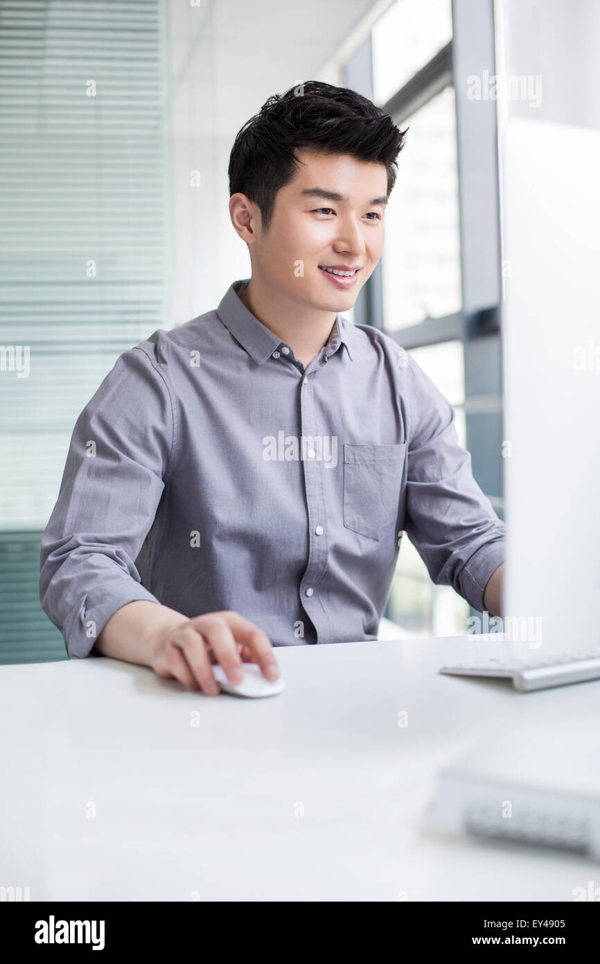 Young businessman using computer in office Stock Photo - Alamy