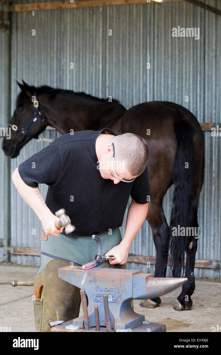 soldier making a reed Doll with traditionally dressed children from the ...