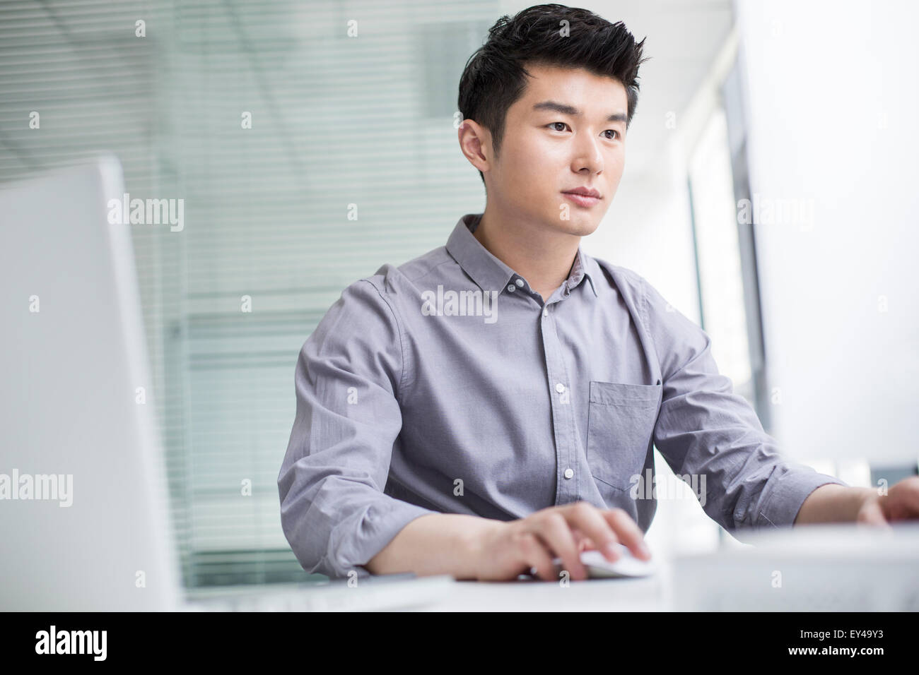Young businessman using computer in office Stock Photo - Alamy