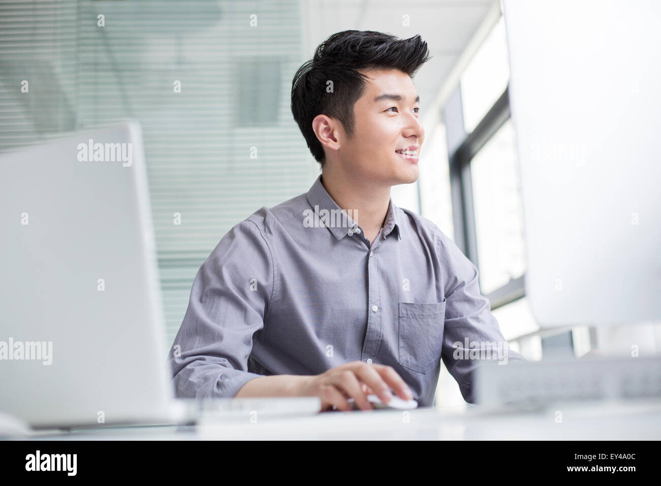 Young businessman using computer in office Stock Photo - Alamy