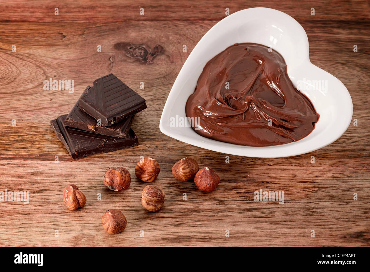 chocolate cream, hazelnut and chocolate on wooden table Stock Photo - Alamy