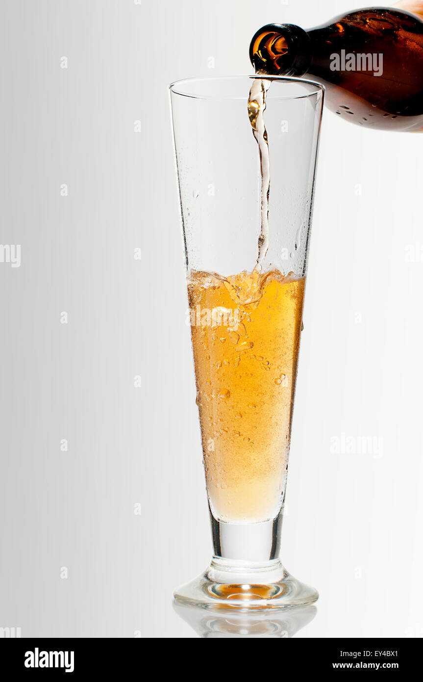 Man Pouring lager Beer into Tall Glass, Close-Up Stock Photo - Alamy