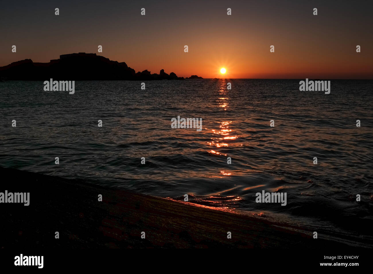 Sunset over Guernsey beach Stock Photo - Alamy
