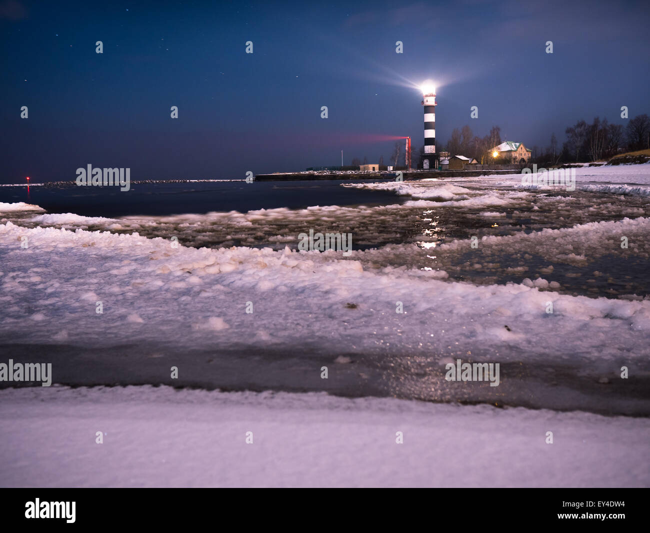 Riga Lighthouse in a starry night with frozen Baltic sea Stock Photo ...