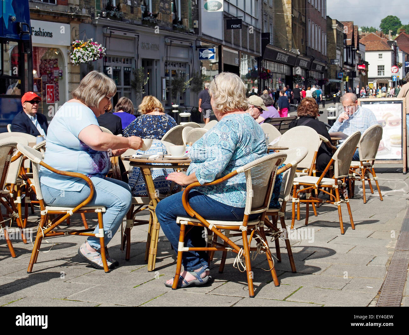 Two larger ladies and other customers enjoying morning coffee outside a ...