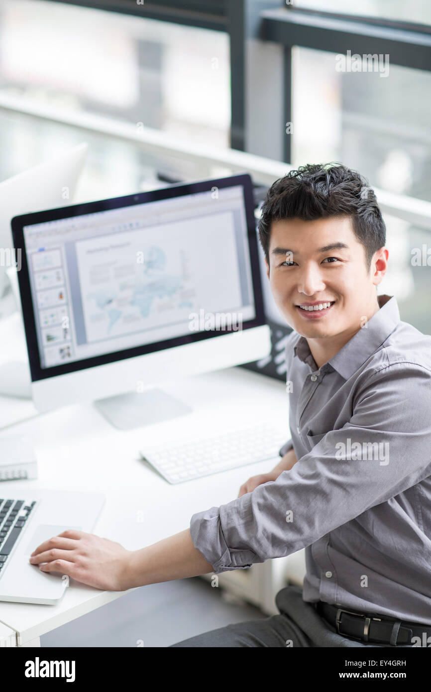 Young businessman using computer in office Stock Photo - Alamy