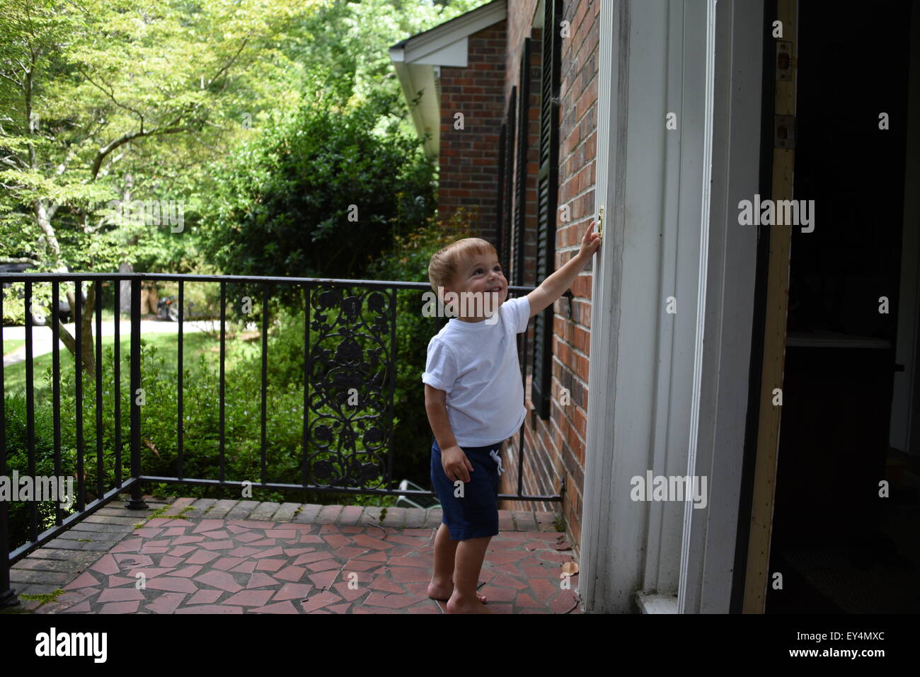 Boy ringing the door bell Stock Photo - Alamy