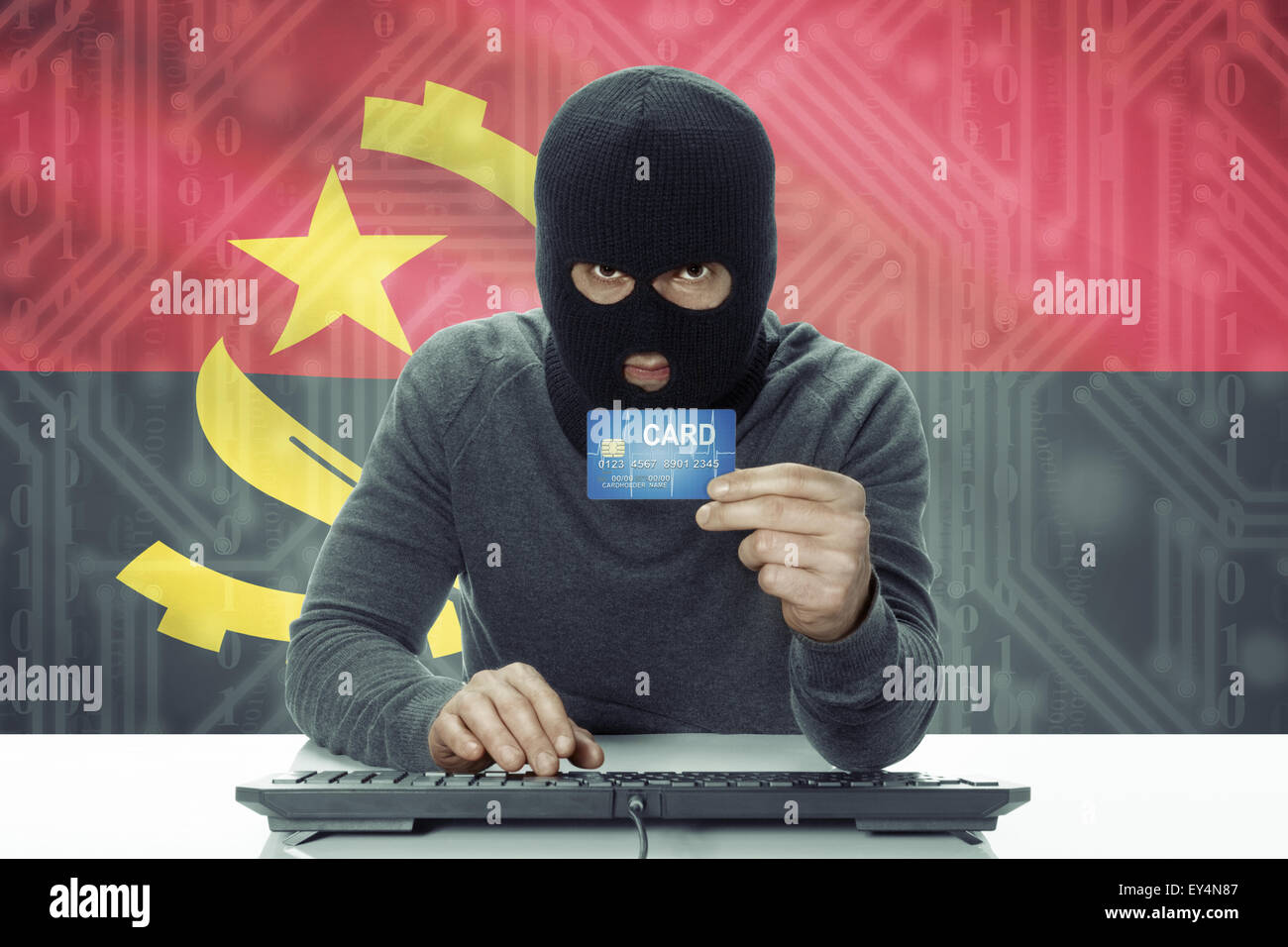 Dark-skinned hacker with credit card and flag on background - Angola ...