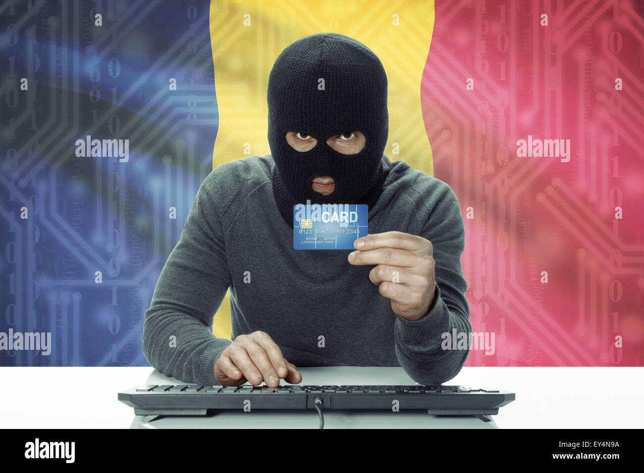 Dark-skinned hacker with credit card and flag on background - Chad ...