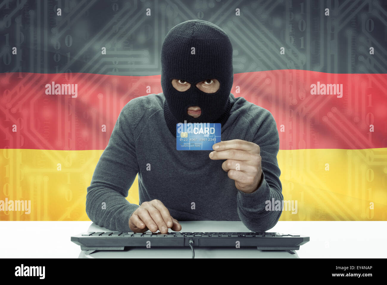 Dark-skinned hacker with credit card and flag on background - Germany ...