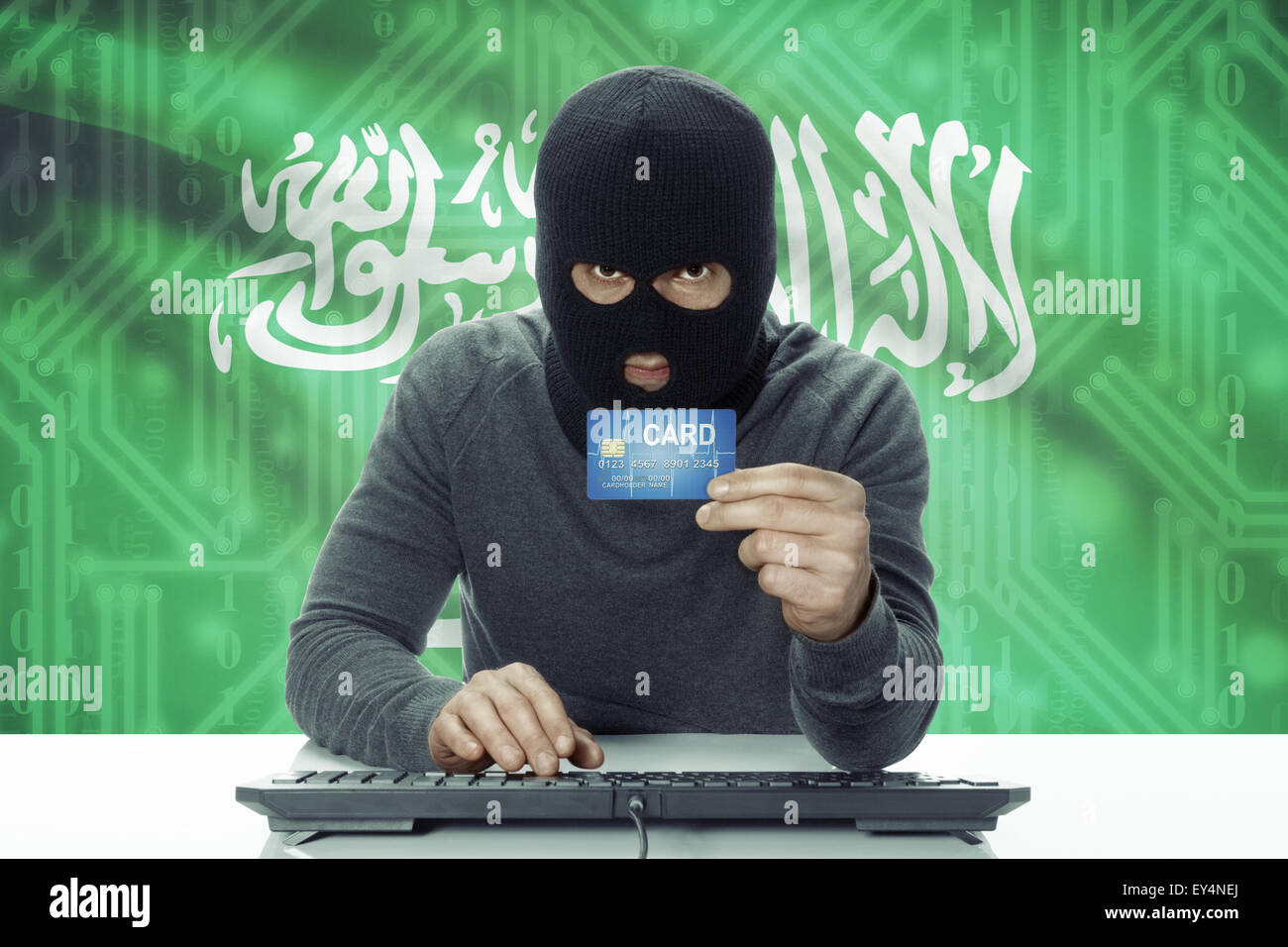 Dark-skinned hacker with credit card and flag on background - Saudi ...