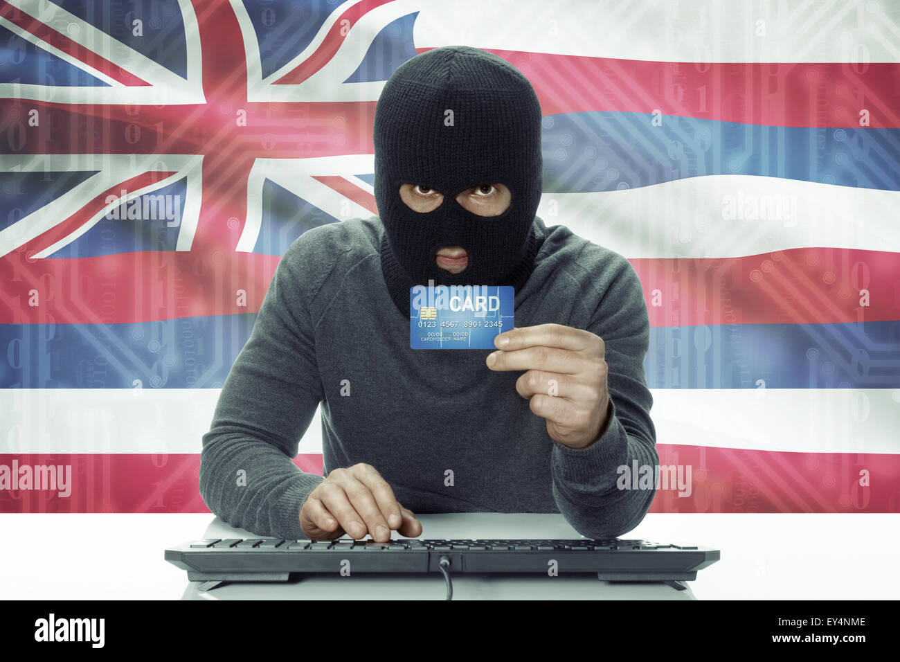 Dark-skinned hacker with credit card and USA states flag on background ...
