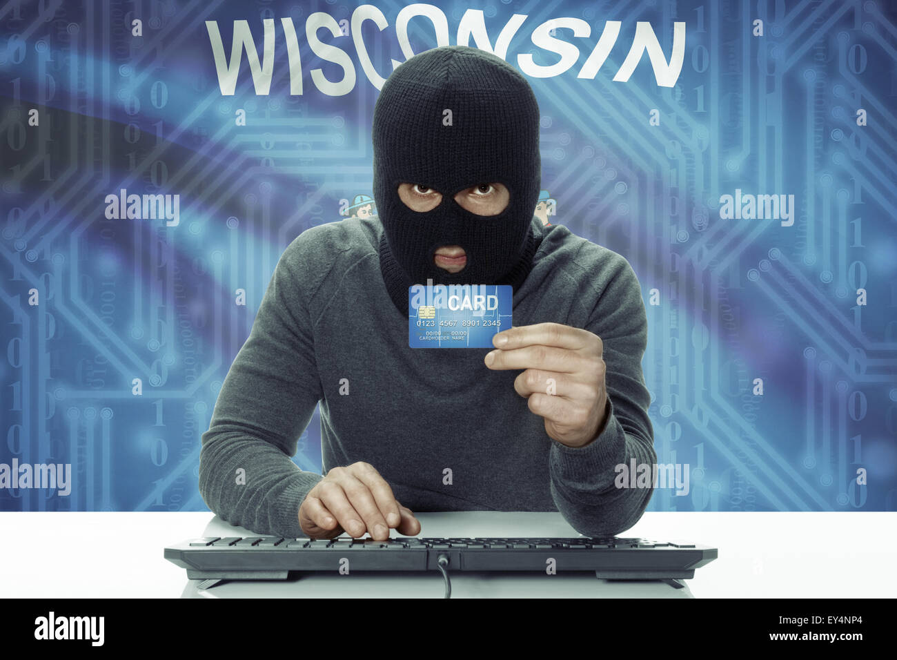 Dark-skinned hacker with credit card and USA states flag on background ...