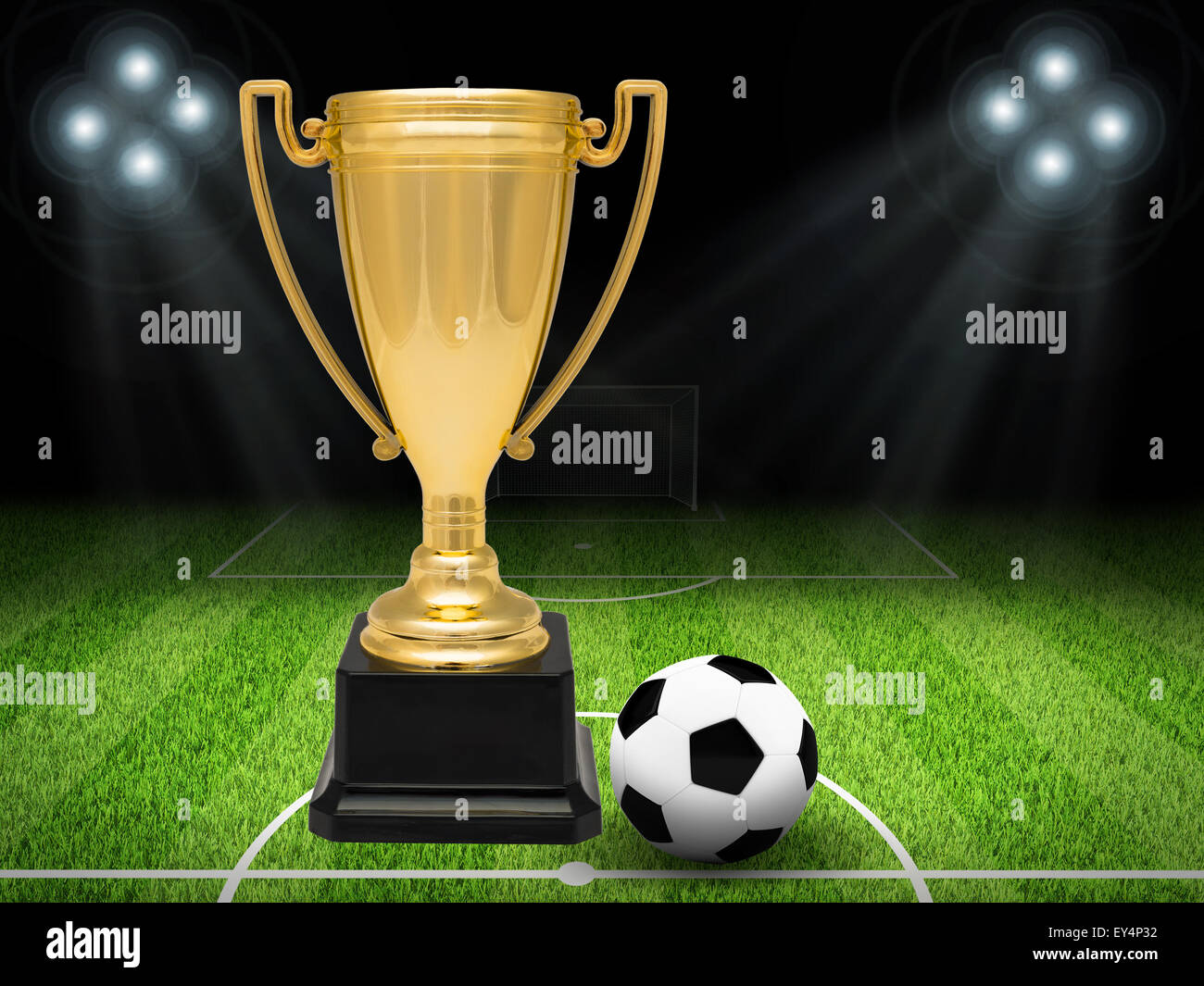 Gold cup with football on pitch Stock Photo - Alamy