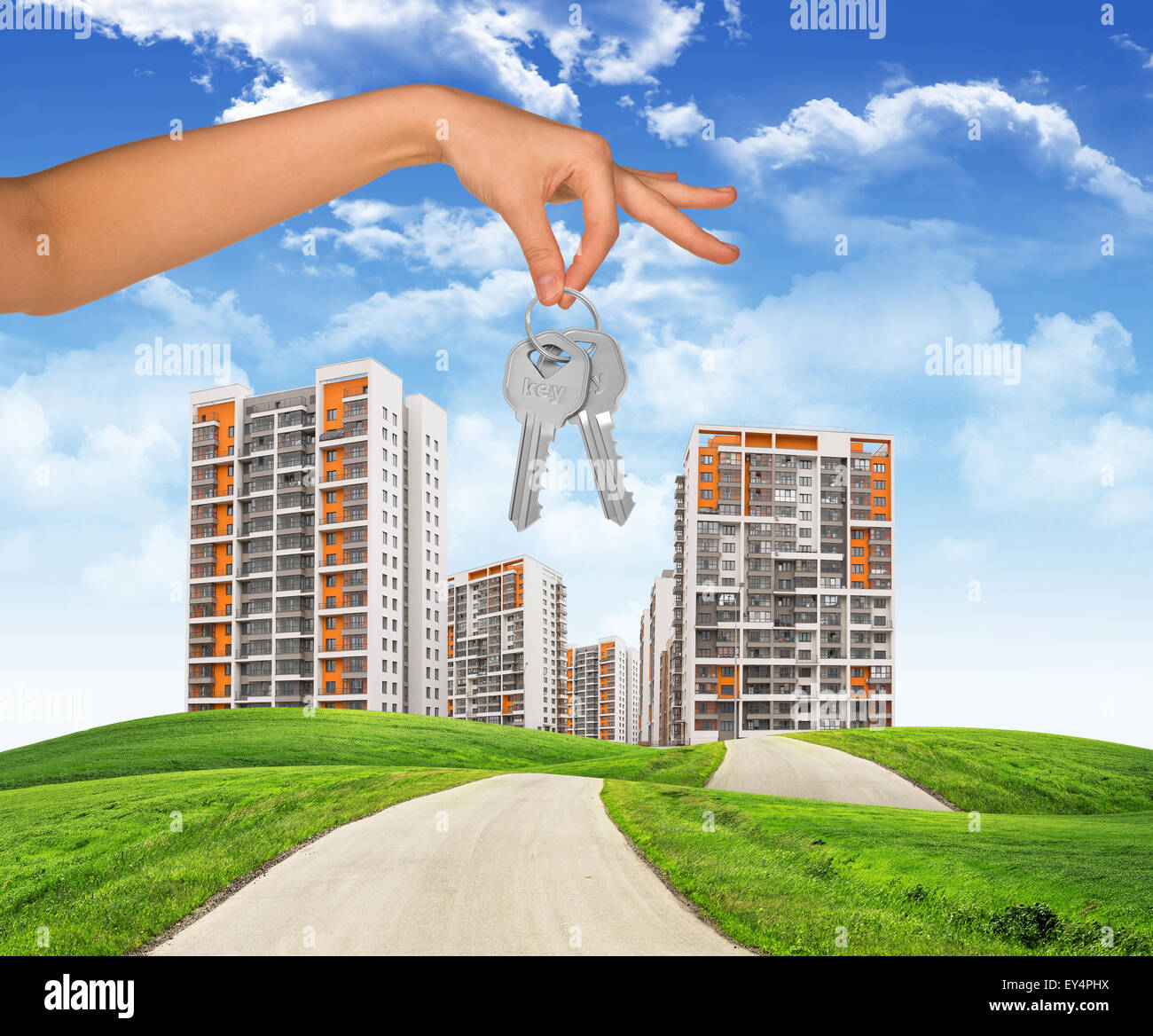 Cityscape under blue sky with hand holding keys Stock Photo - Alamy