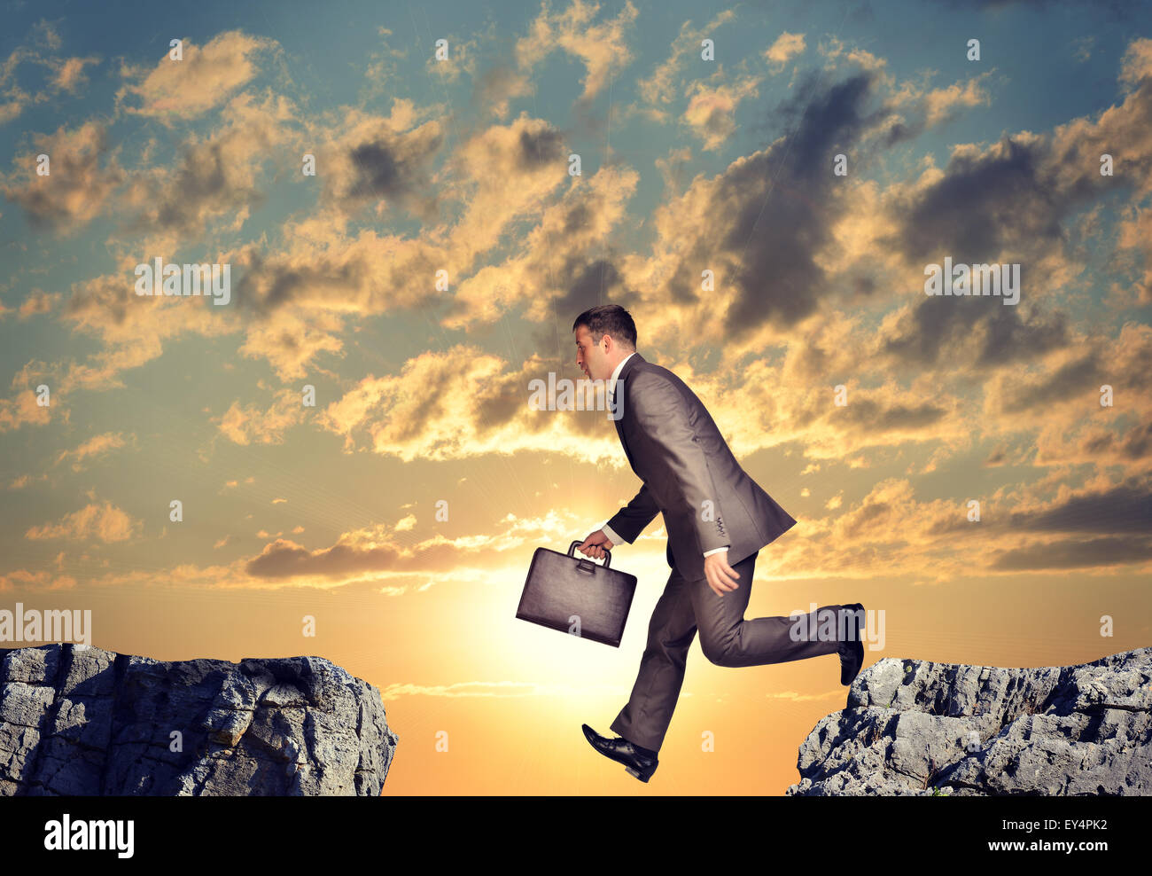 Businessman falling into abyss Stock Photo - Alamy