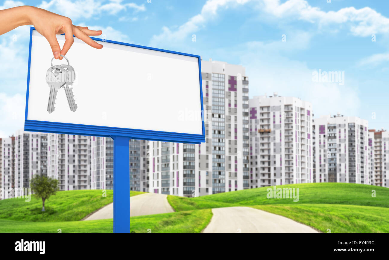 Hand holding keys and billboard Stock Photo - Alamy