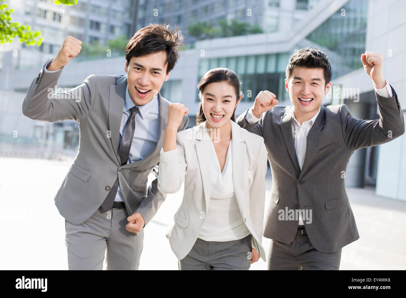 Young business person cheering Stock Photo - Alamy