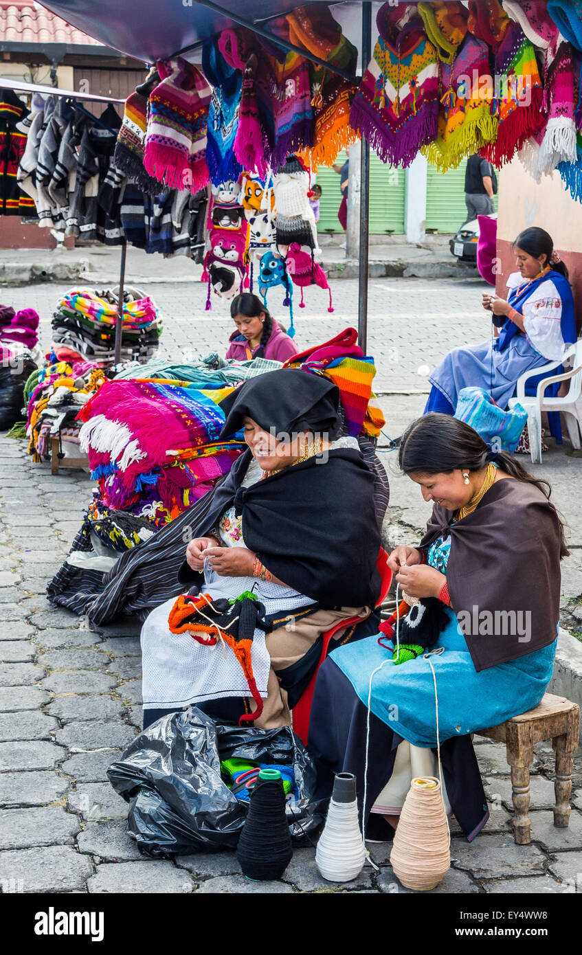 Native women hand knit colorful hats at local market. Otavalo, Ecuador ...