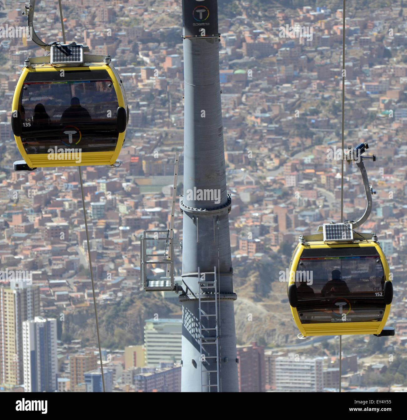 Cable car cabins of the yellow line connect the cities of El Alto ...