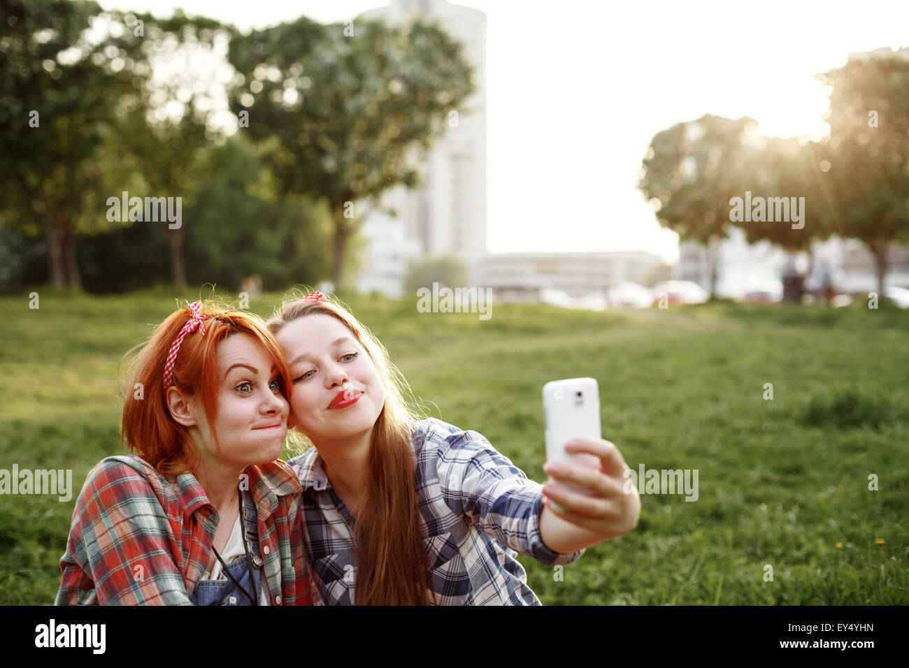 Two Young Hipster Girls Having Fun And Taking Photos Making Selfie On