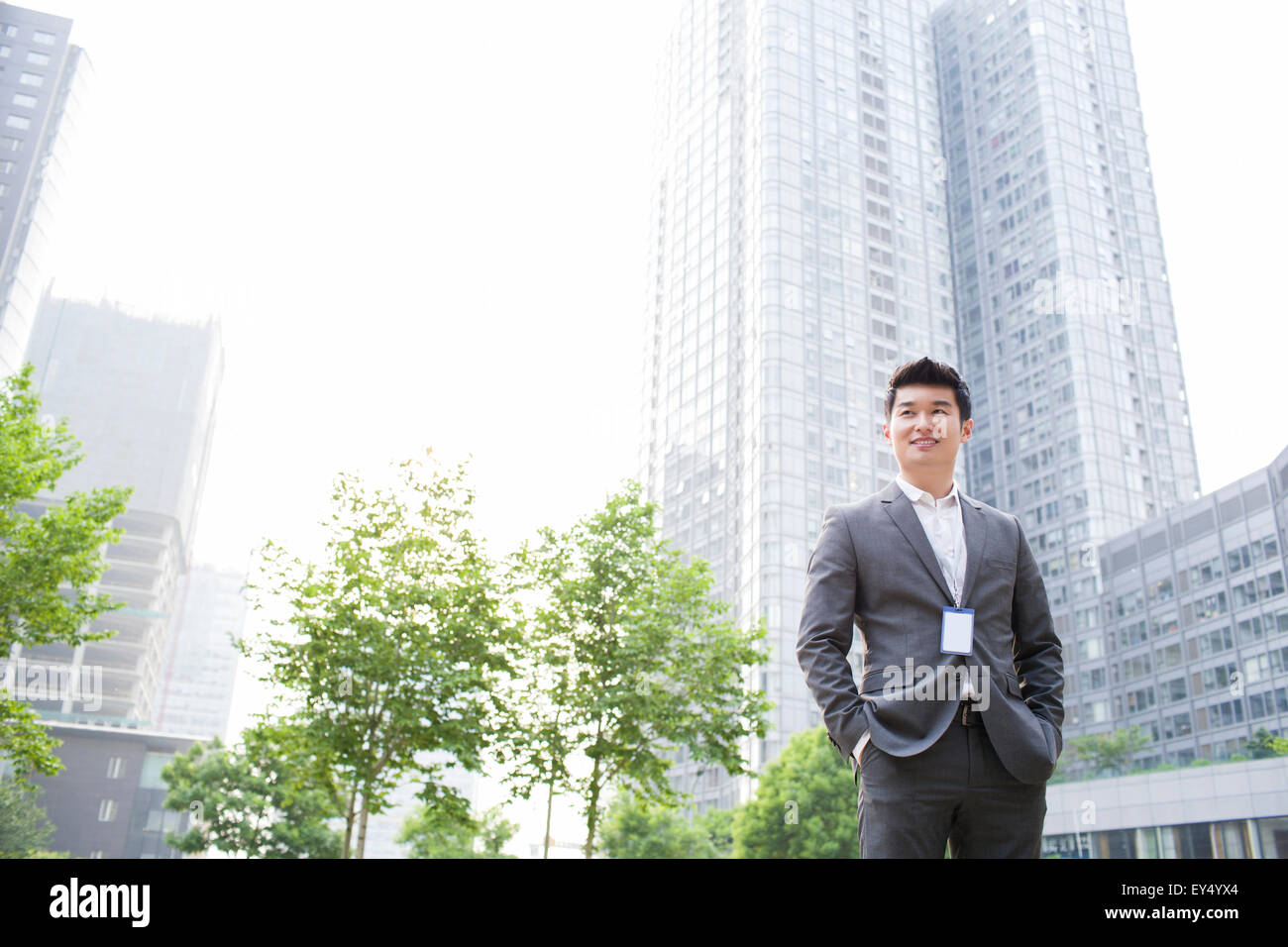 Young businessman looking at view Stock Photo - Alamy