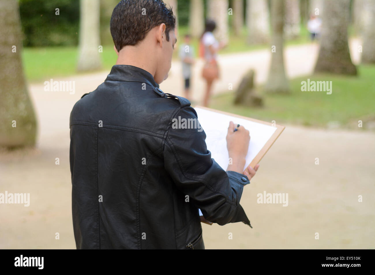 Male artist drawing, at a peaceful place Stock Photo - Alamy
