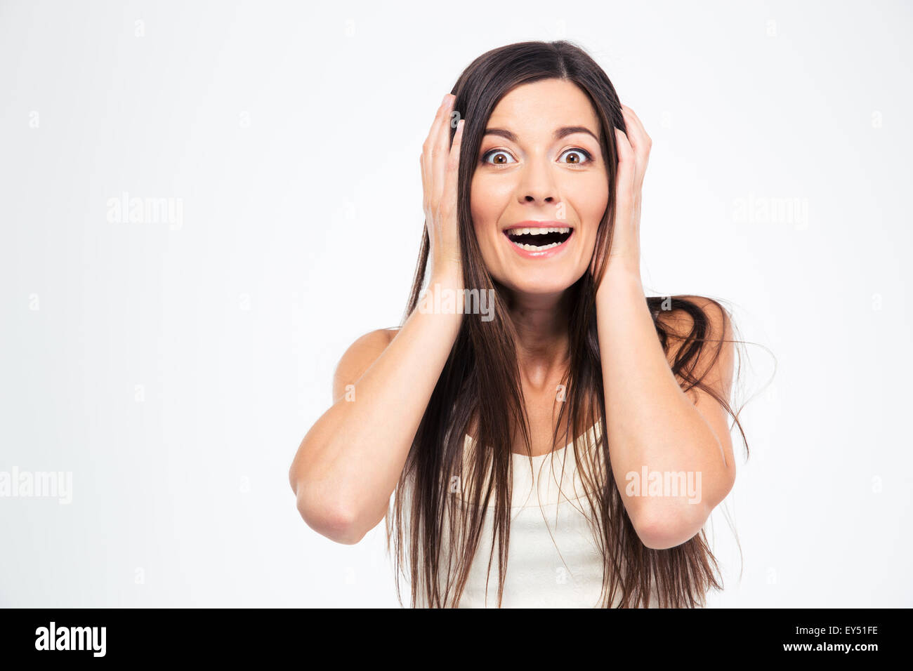 Portrait of a amazed woman looking at camera isolated on a white ...