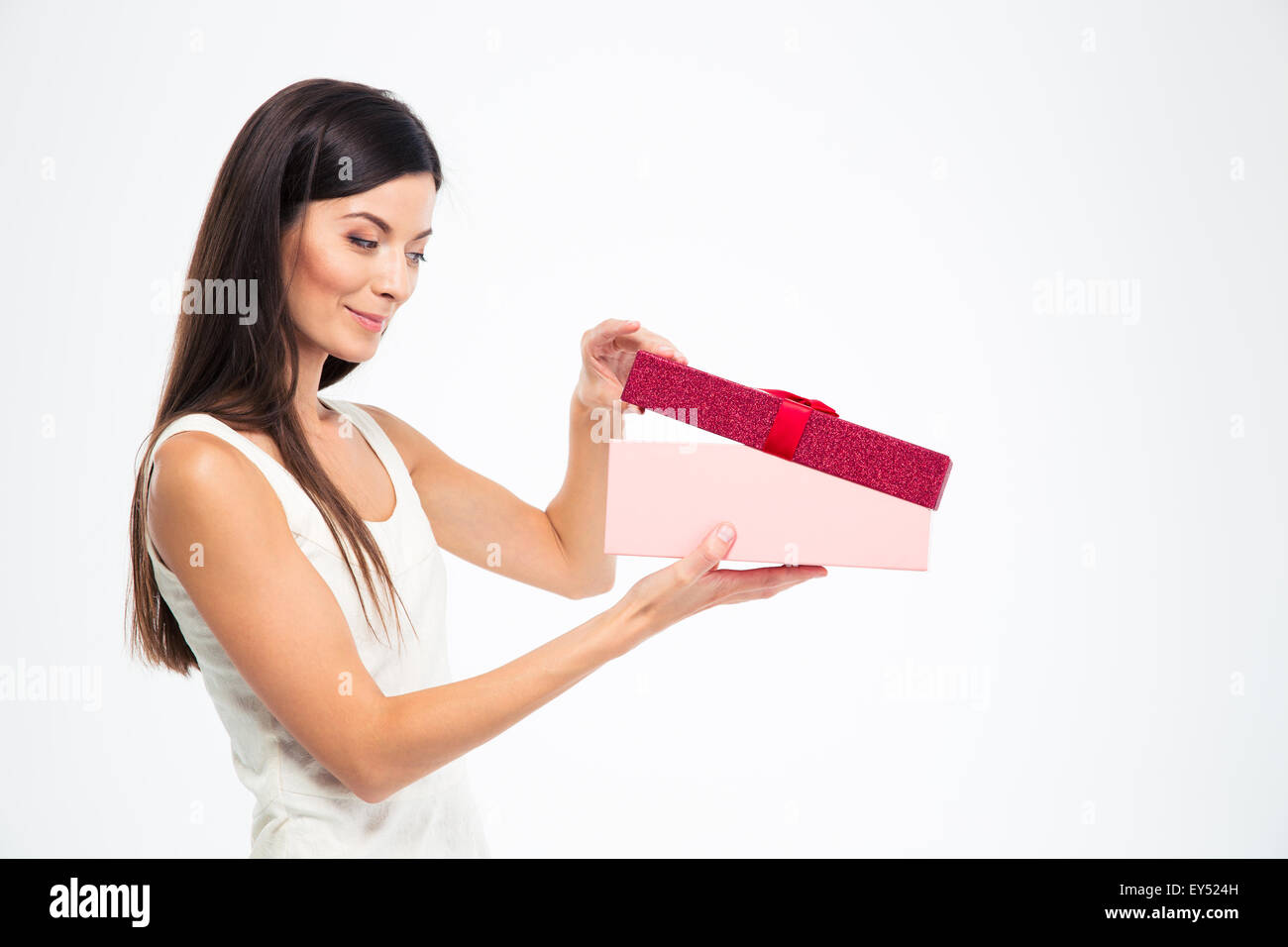 Happy young woman opening gift box isolated on a white background Stock ...