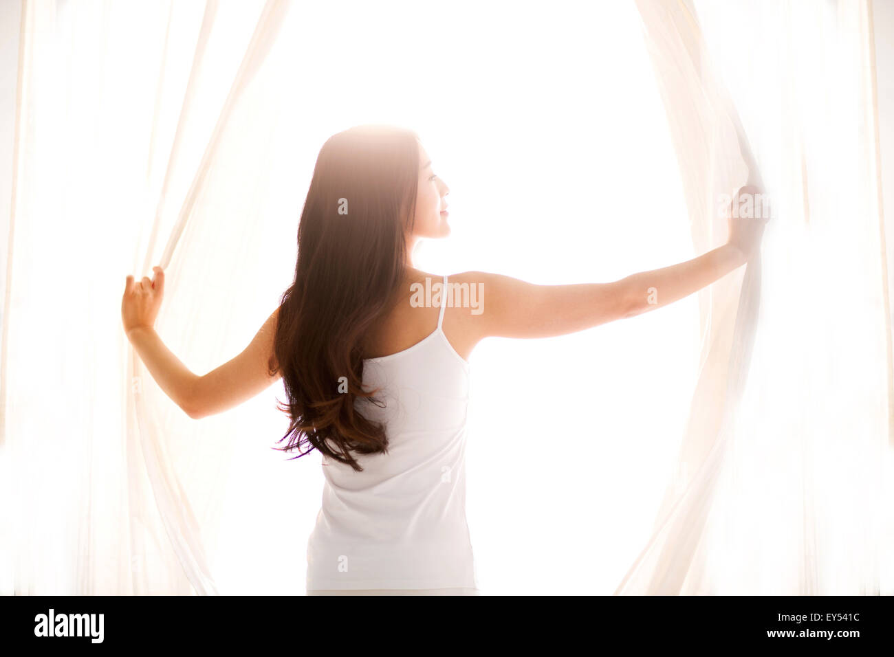 Young woman getting up Stock Photo - Alamy