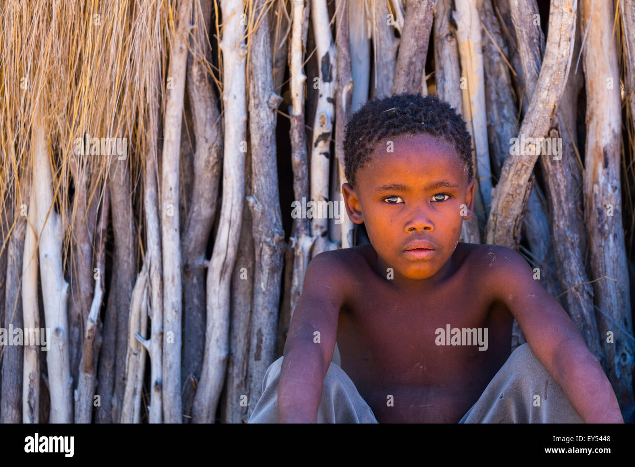 Bushman child in front of a hut - Kalahari Botswana Stock Photo - Alamy
