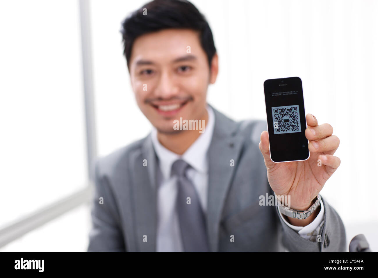 Portrait of businessman holding cellphone with Binary Code Stock Photo ...