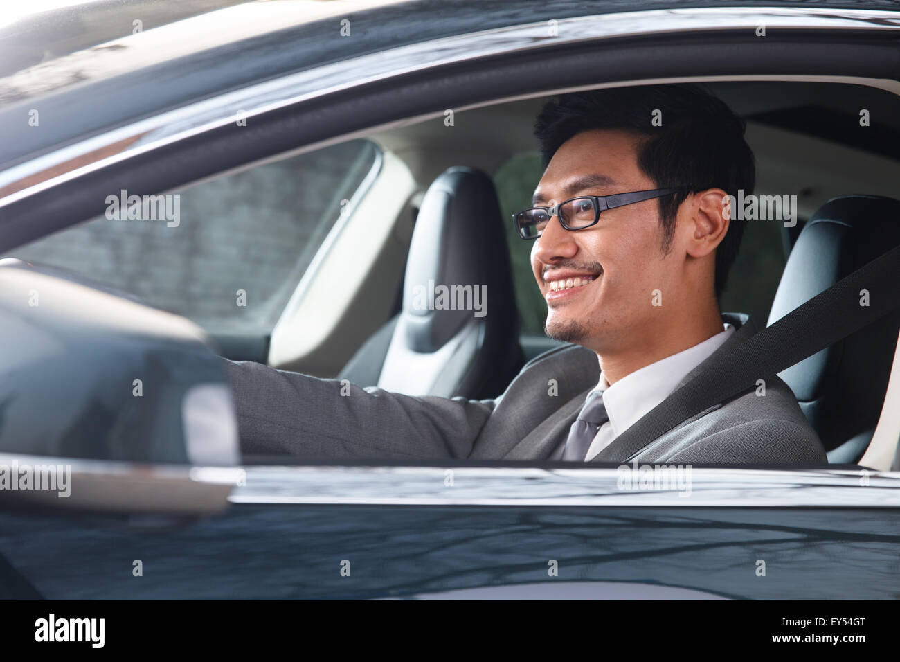 Businessman driving in car Stock Photo - Alamy