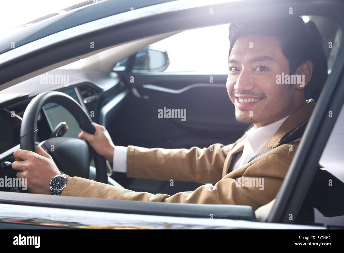 Businessman driving in car Stock Photo - Alamy