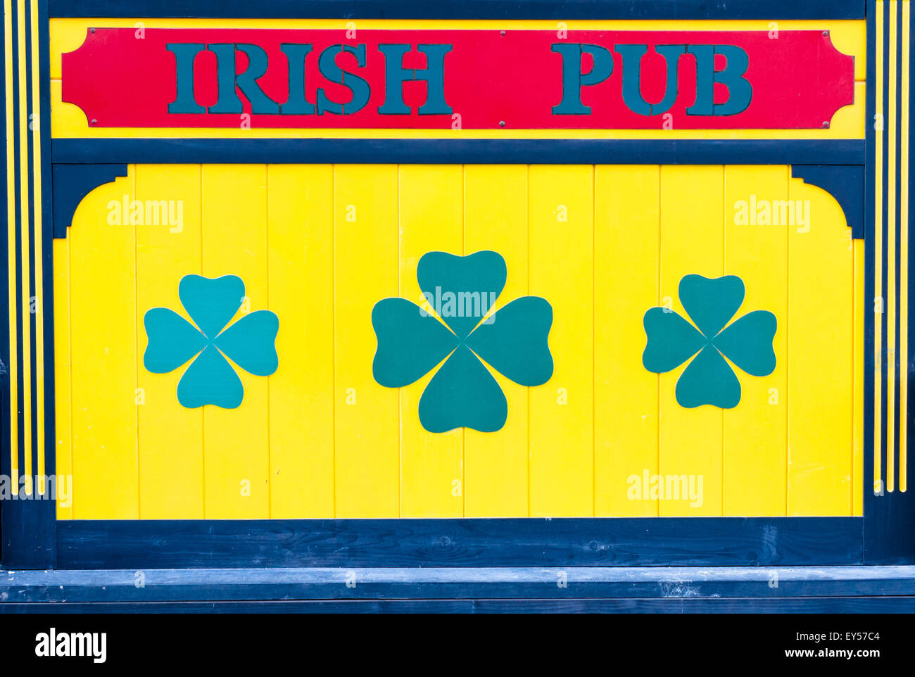 Bright colorful Irish Pub sign in yellow and blue on a wooden ...