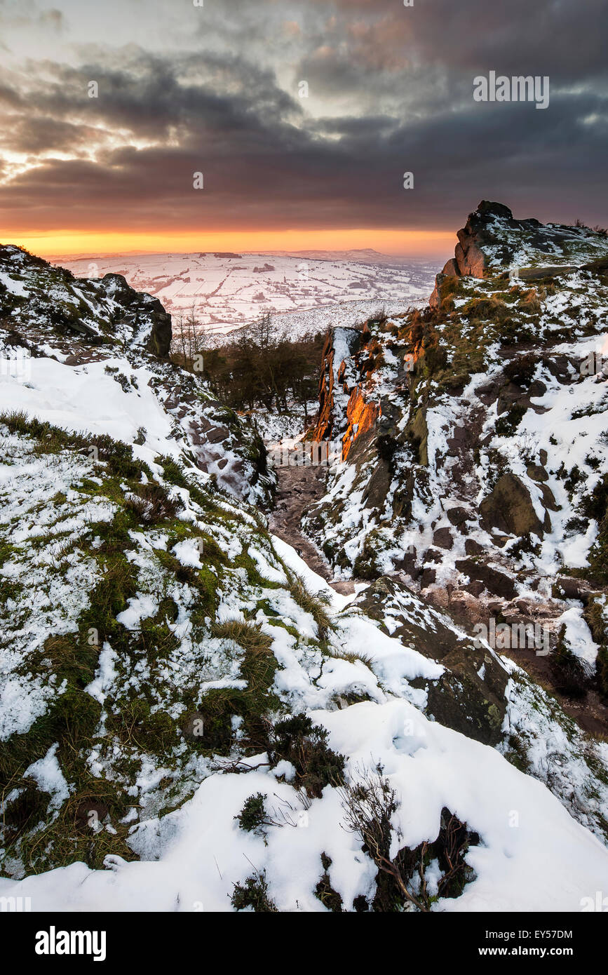 Stunning Winter sunset over countryside landscape with moody sky and ...