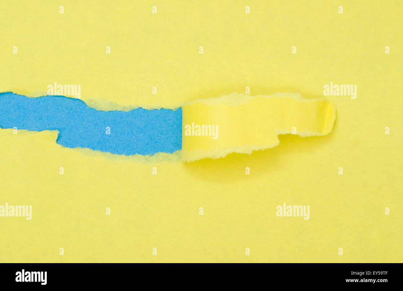 Yellow torn paper on blue background Stock Photo - Alamy