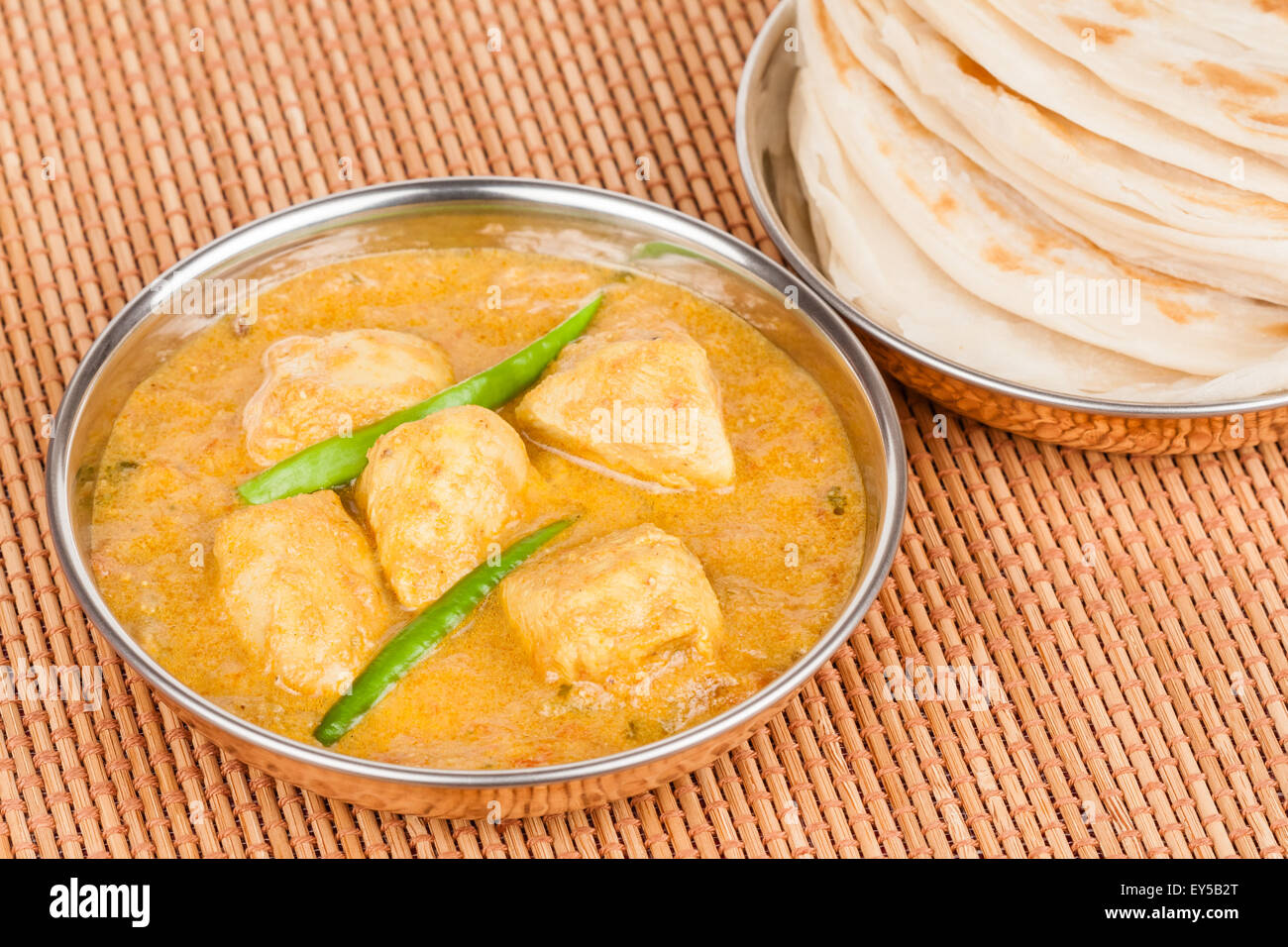 Indian chicken curry served with parotta (indian bread) in authentic ...