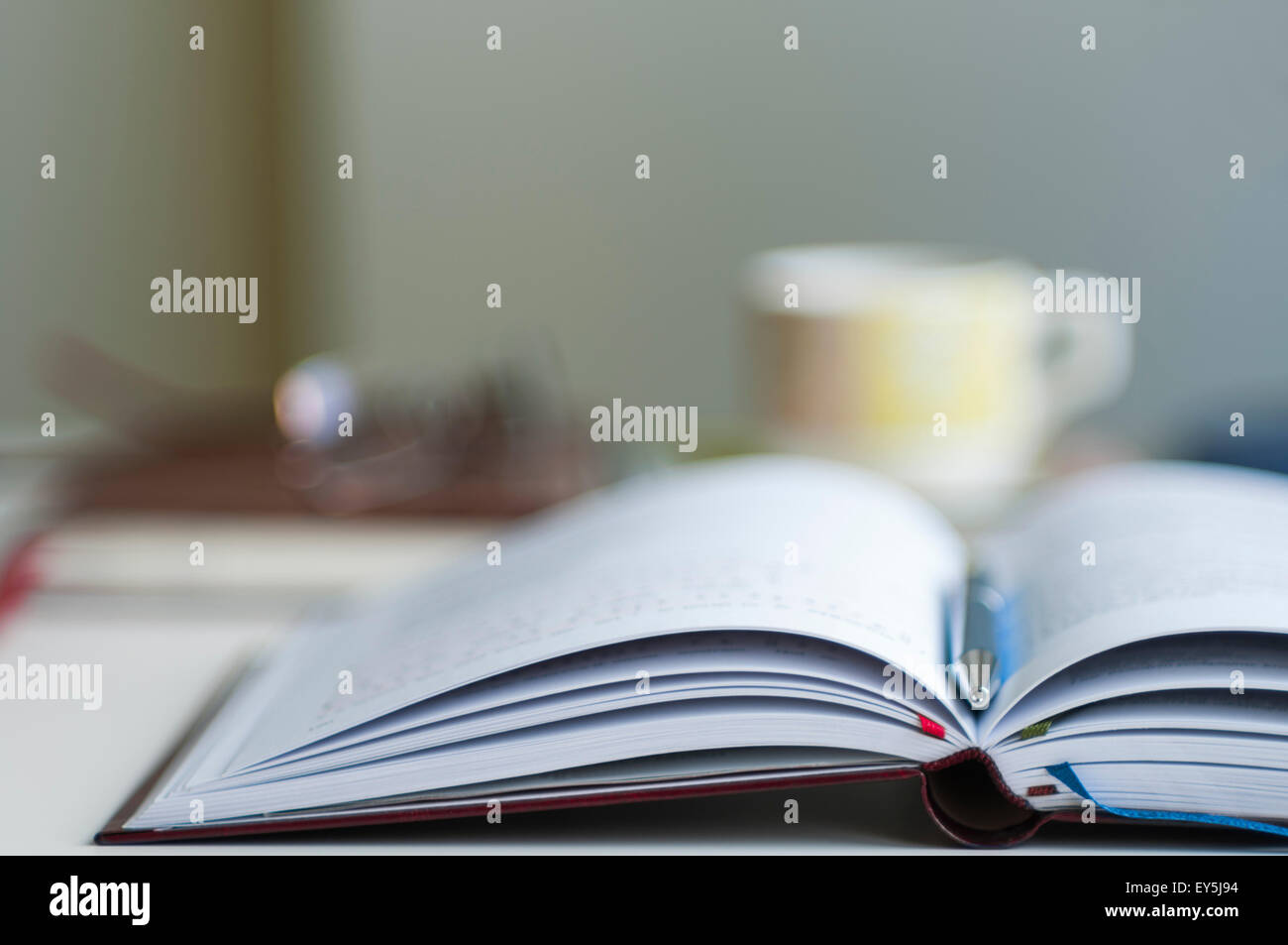 Close up of open notebook blurred with very shallow depth of field ...