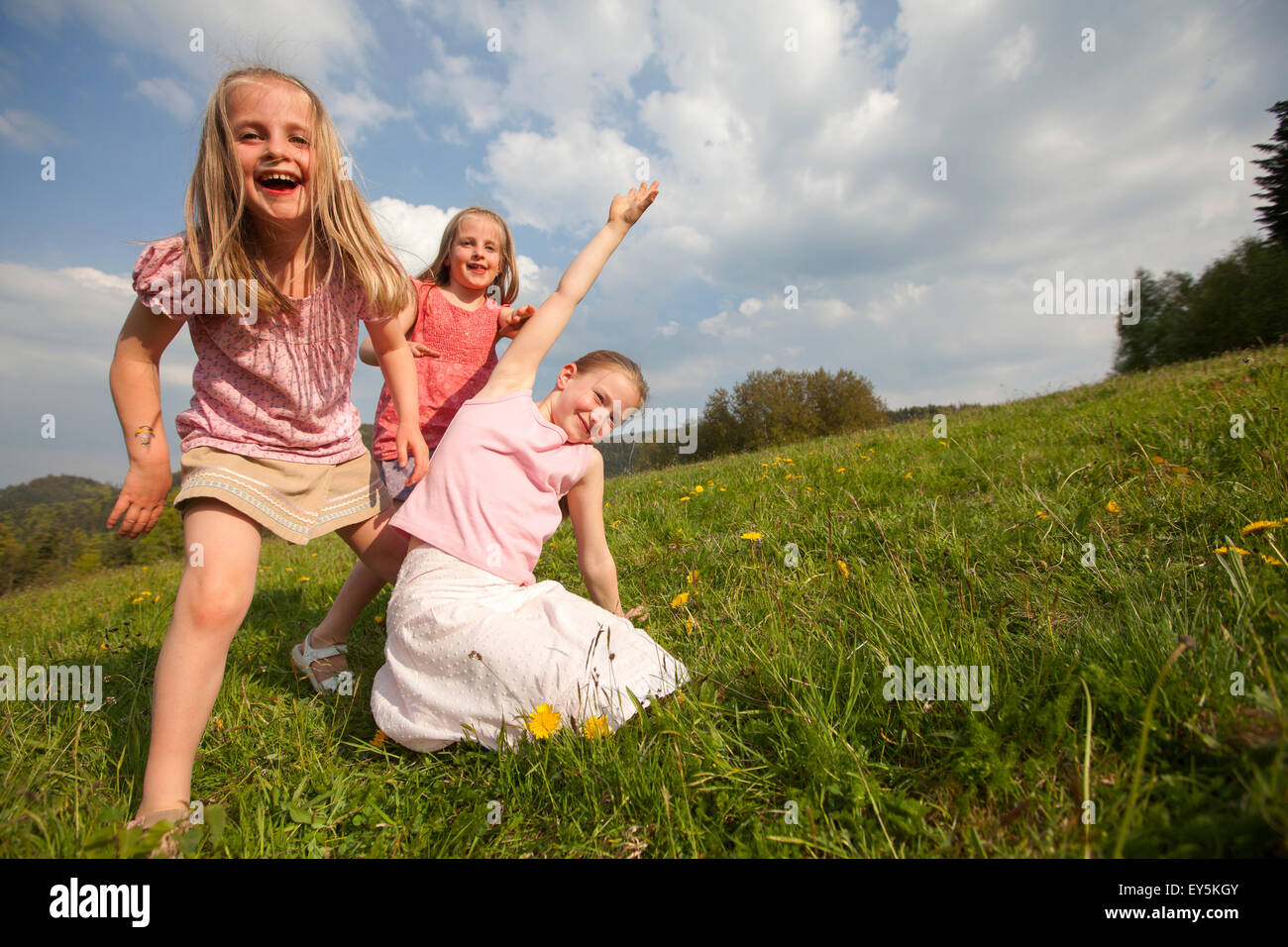 Young girls playing in a meadow in spring - Alsace France Stock Photo ...