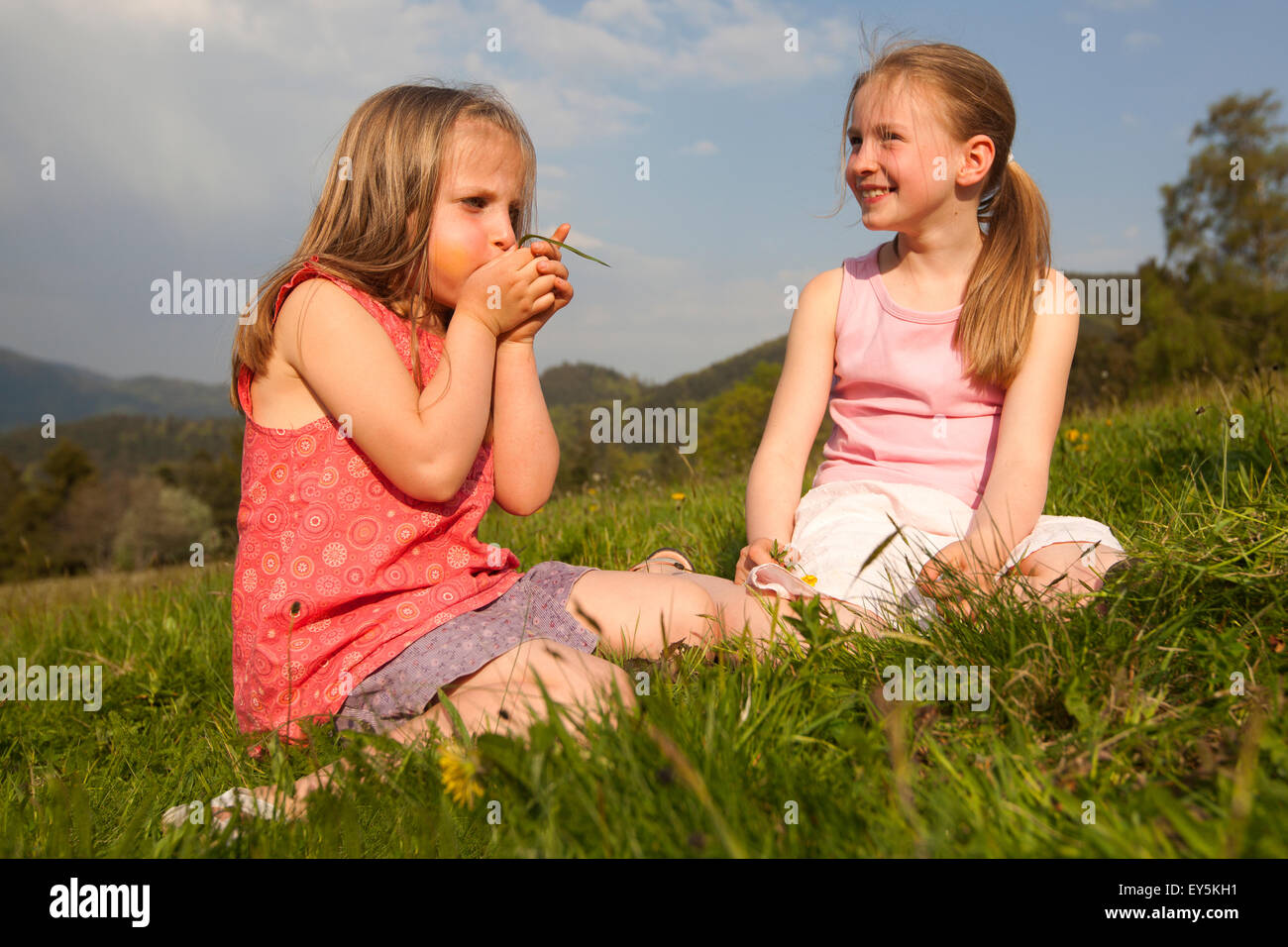 Young girls playing in a meadow in spring - Alsace France Stock Photo ...