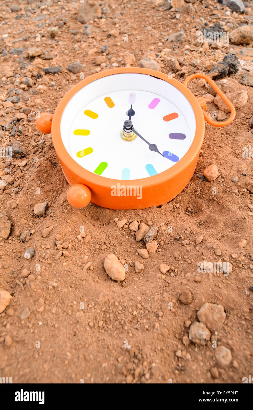 Classic Analog Clock In The Sand Stock Photo - Alamy